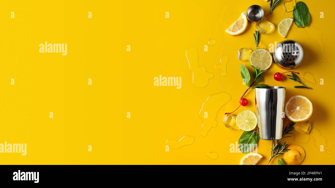 Shaker with ingredients for making cocktails. Yellow background with ...
