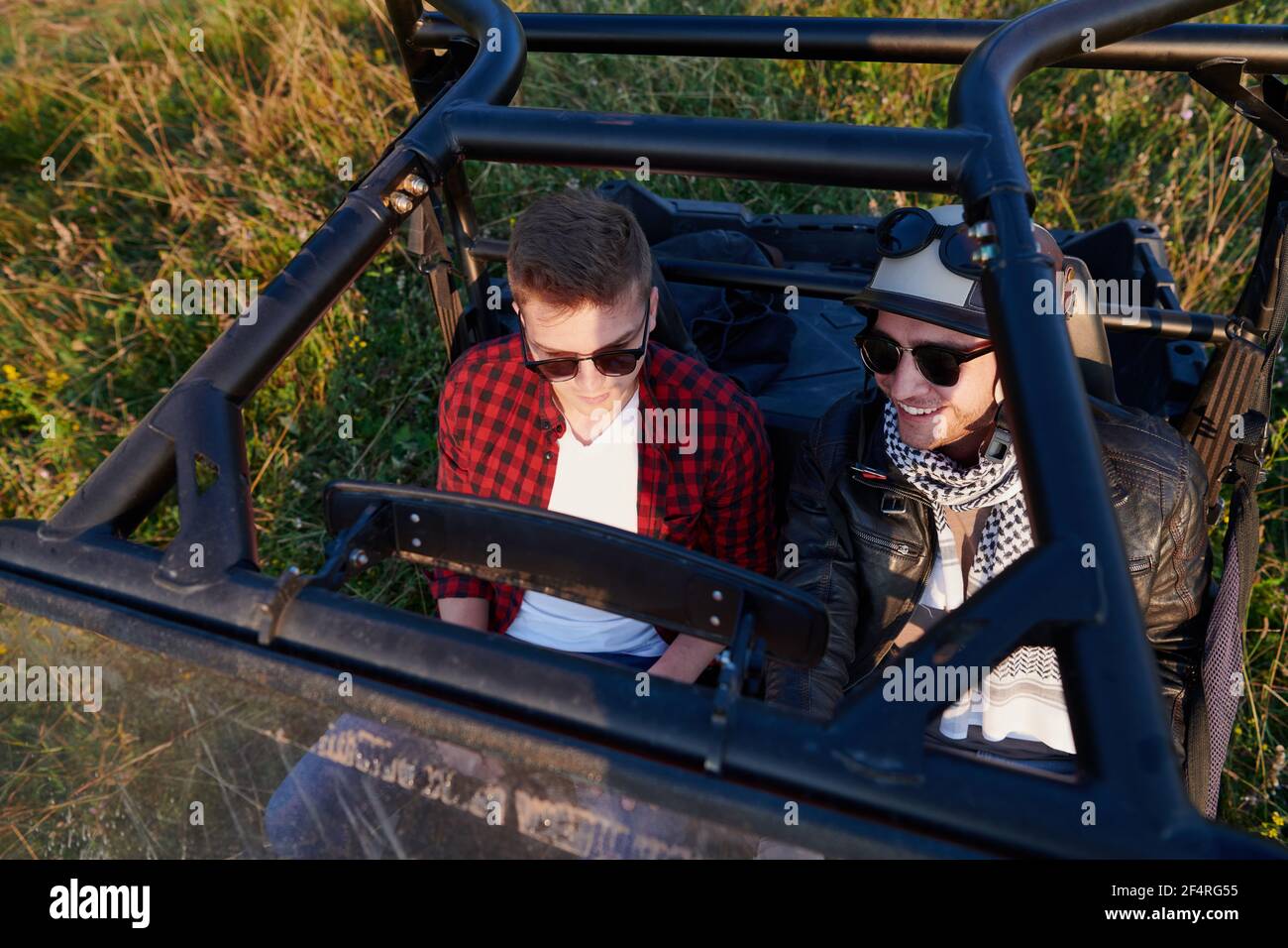 two young happy excited men enjoying beautiful sunny day while driving ...