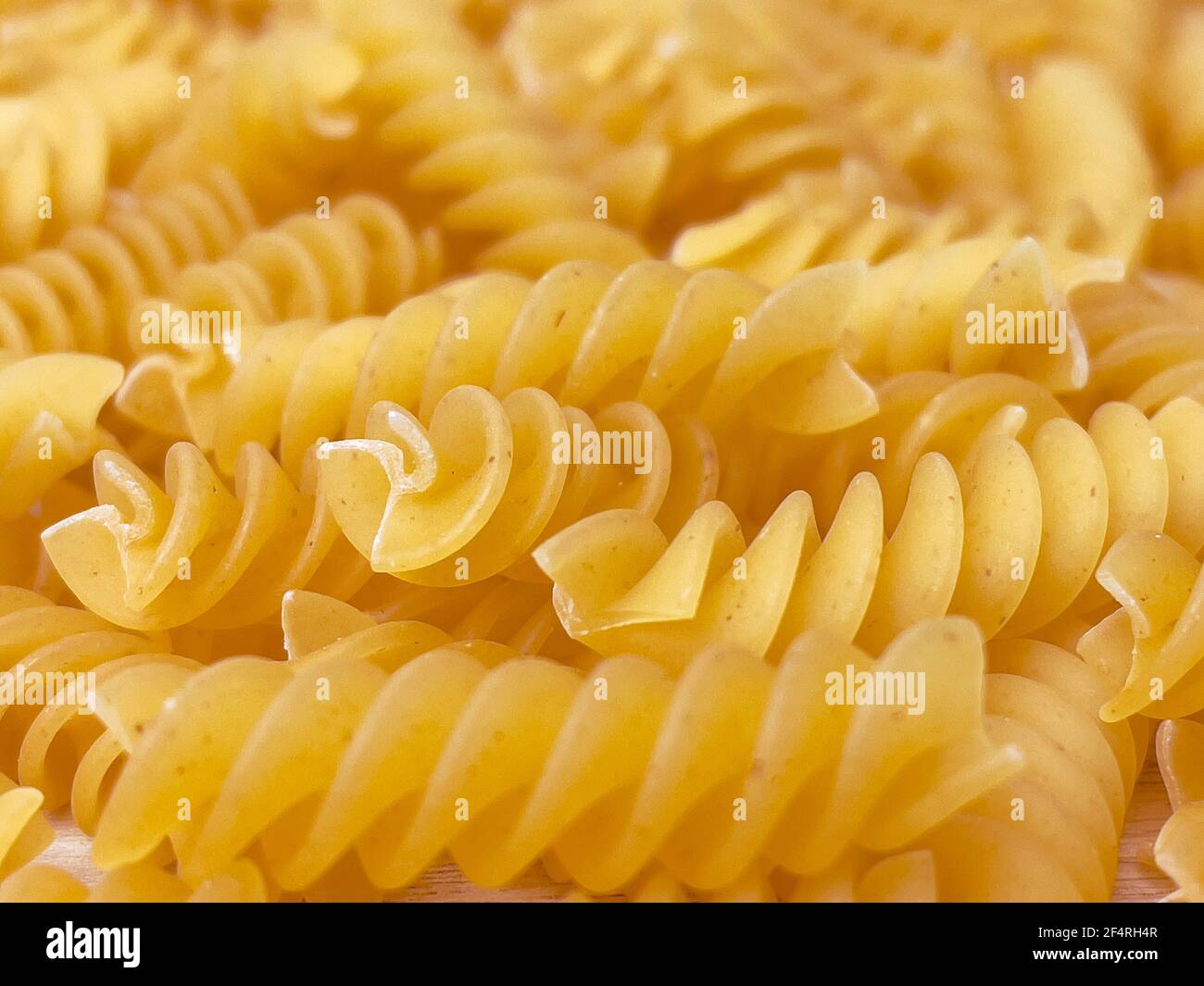 Food background or texture raw dry Italian pasta in shape of spiral ...
