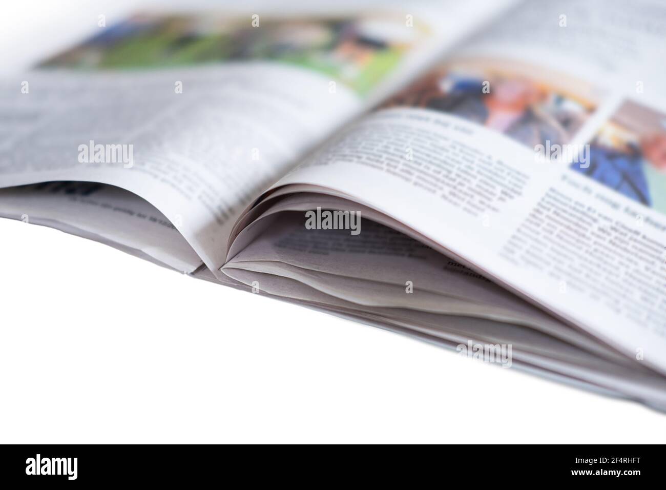 Open magazine with color photos and unread text with narrow depth of ...