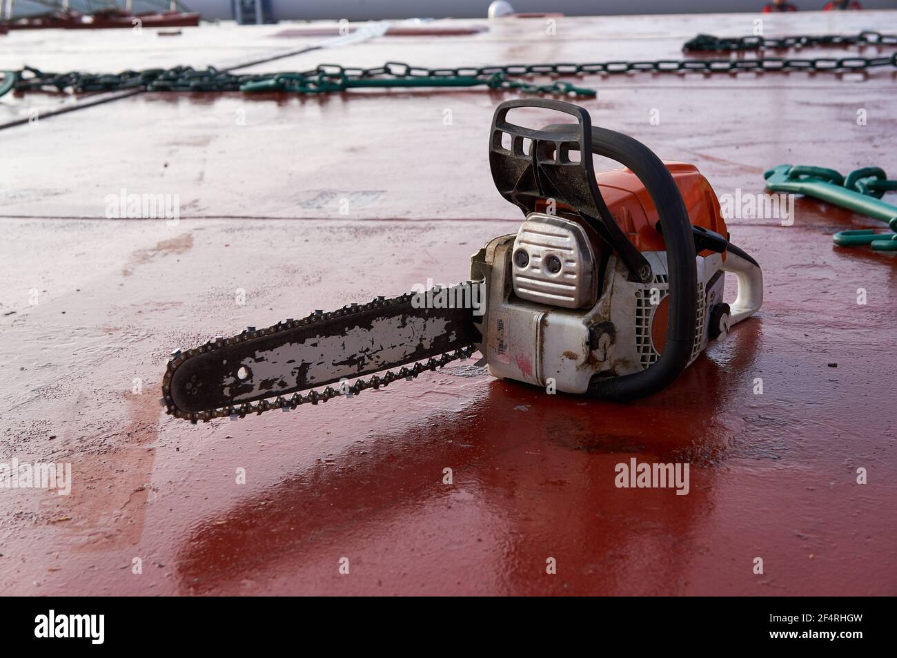 Chain saw laying on deck of ship and used for lashing of cargo. Cargo ...
