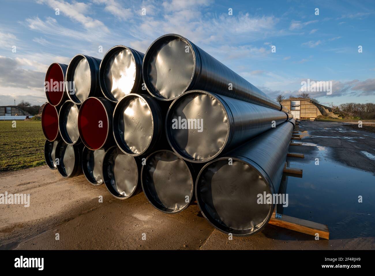 A stack of pipes on the construction site of a gas pipeline that will ...