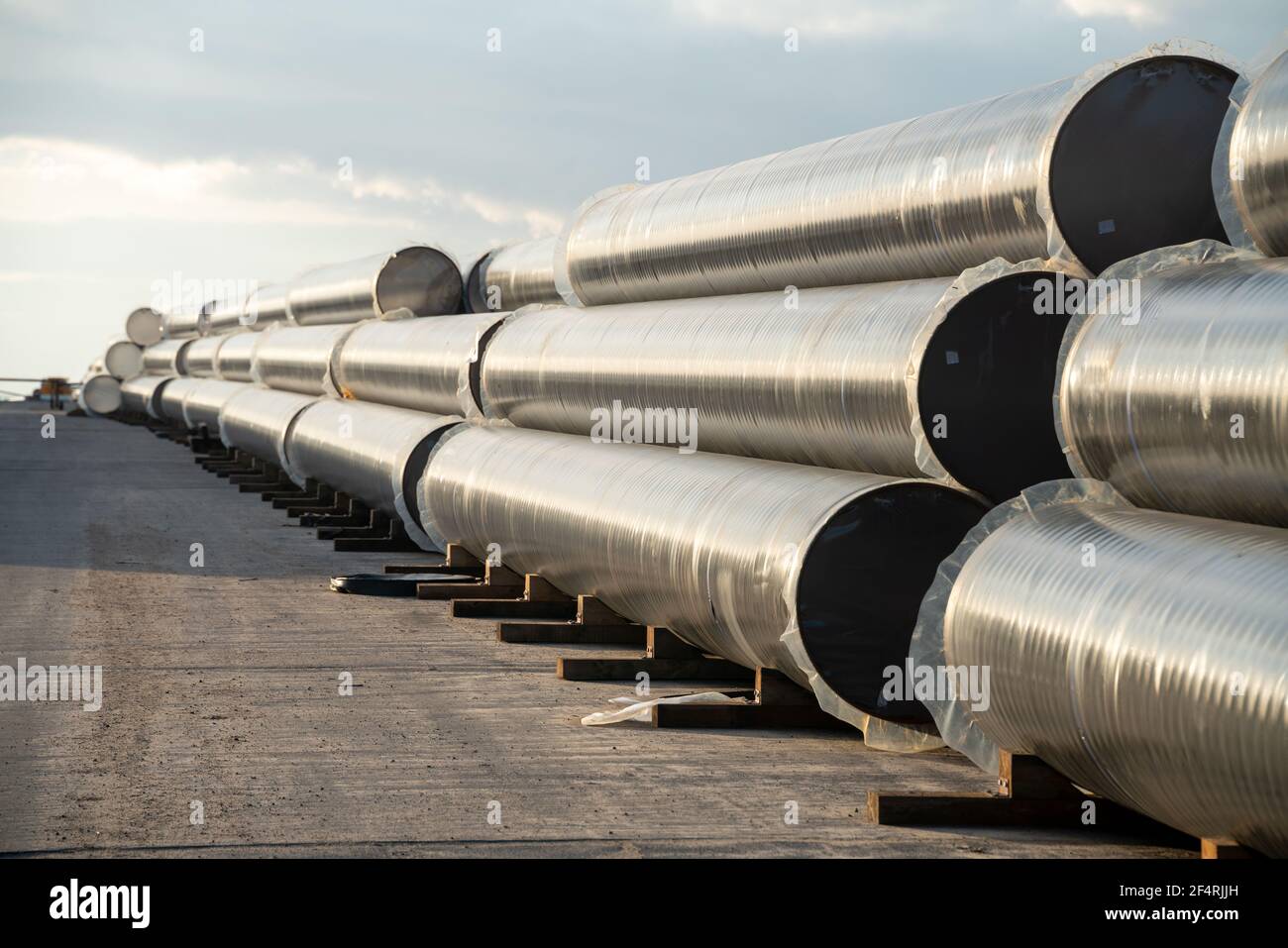 A stack of pipes on the construction site of a gas pipeline that will ...