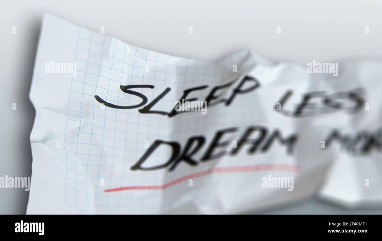 Sleep less and dream more words on torn paper Stock Photo - Alamy