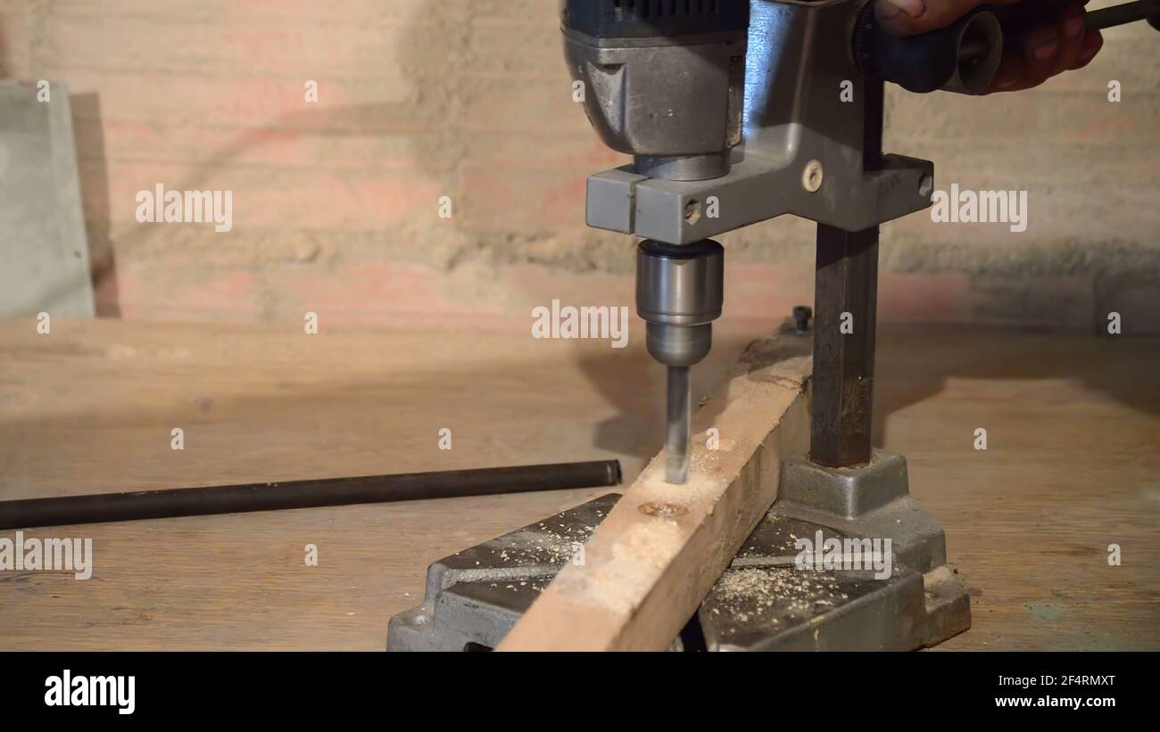 hand drill boring a hole on a wood board Stock Photo - Alamy