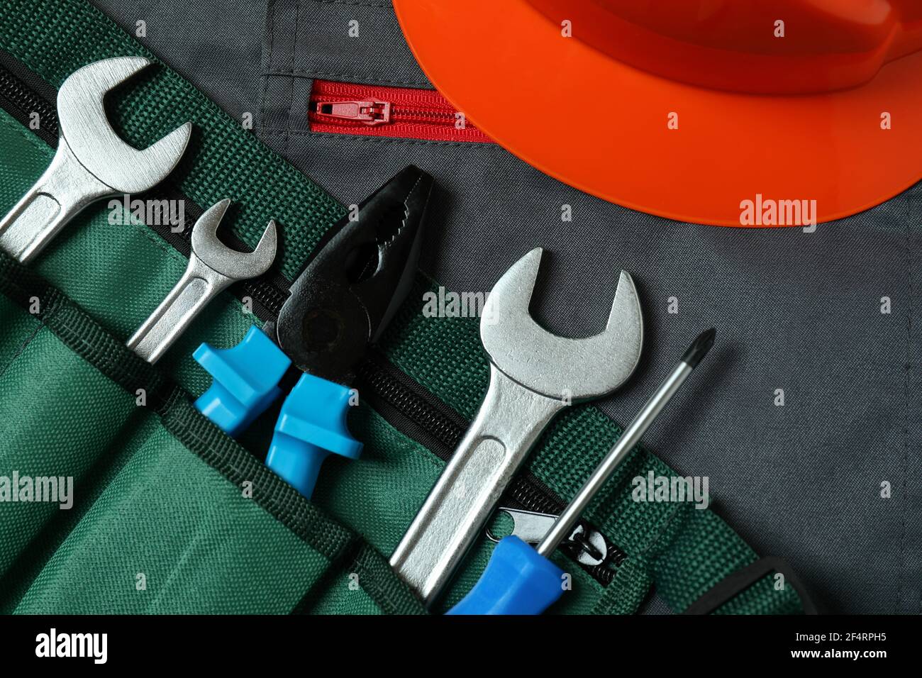 Overalls, hard hat and working tools, close up Stock Photo - Alamy