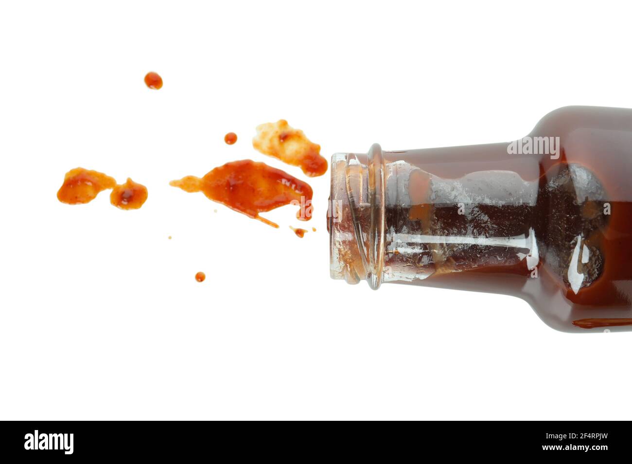 Bottle of barbecue sauce and splashes isolated on white background ...