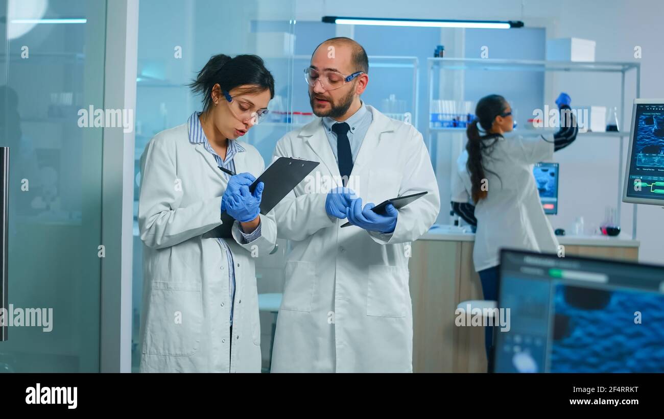 Group of medical researchers discussing about vaccine development ...