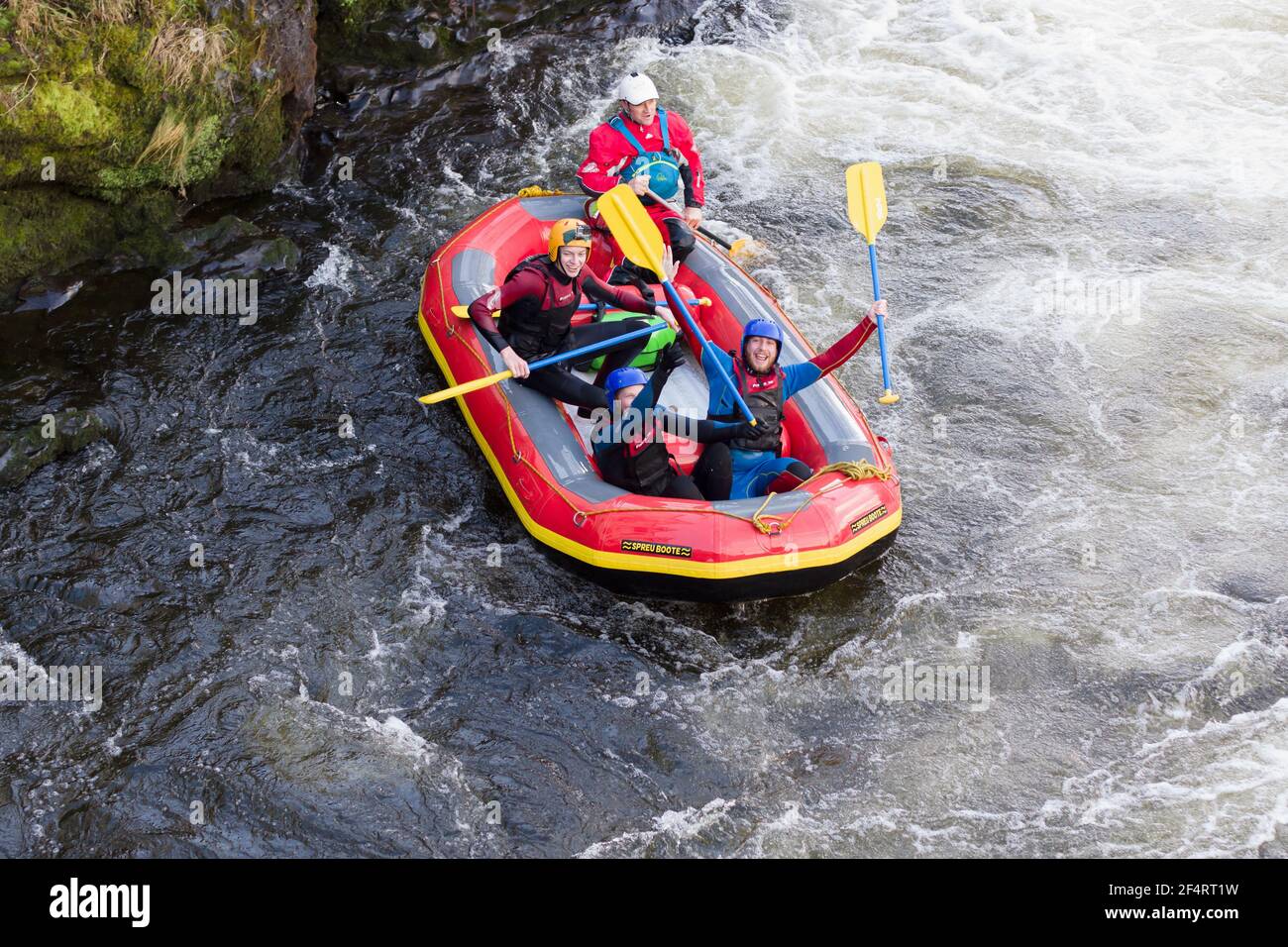 People taking part in a team building white water rafting event on the ...