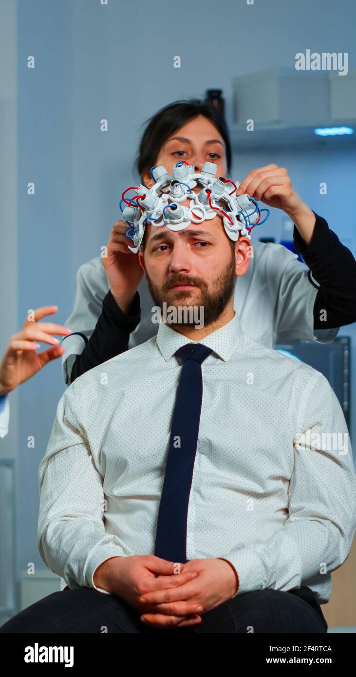 Neurological researchers explaning treatment result pointing on monitor ...