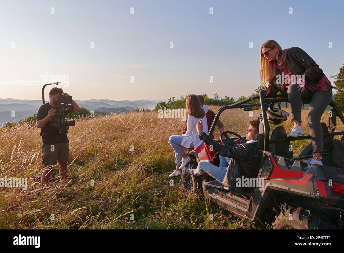 cameramen with professional equipment film a group of young people ...