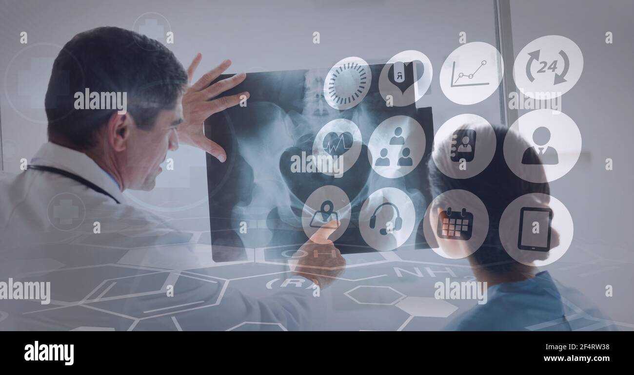 Multiple medical icons against male senior doctor examining x-ray ...