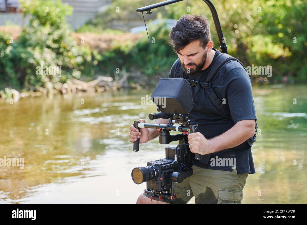 a professionally equipped cameraman shoots in the water surrounded by ...