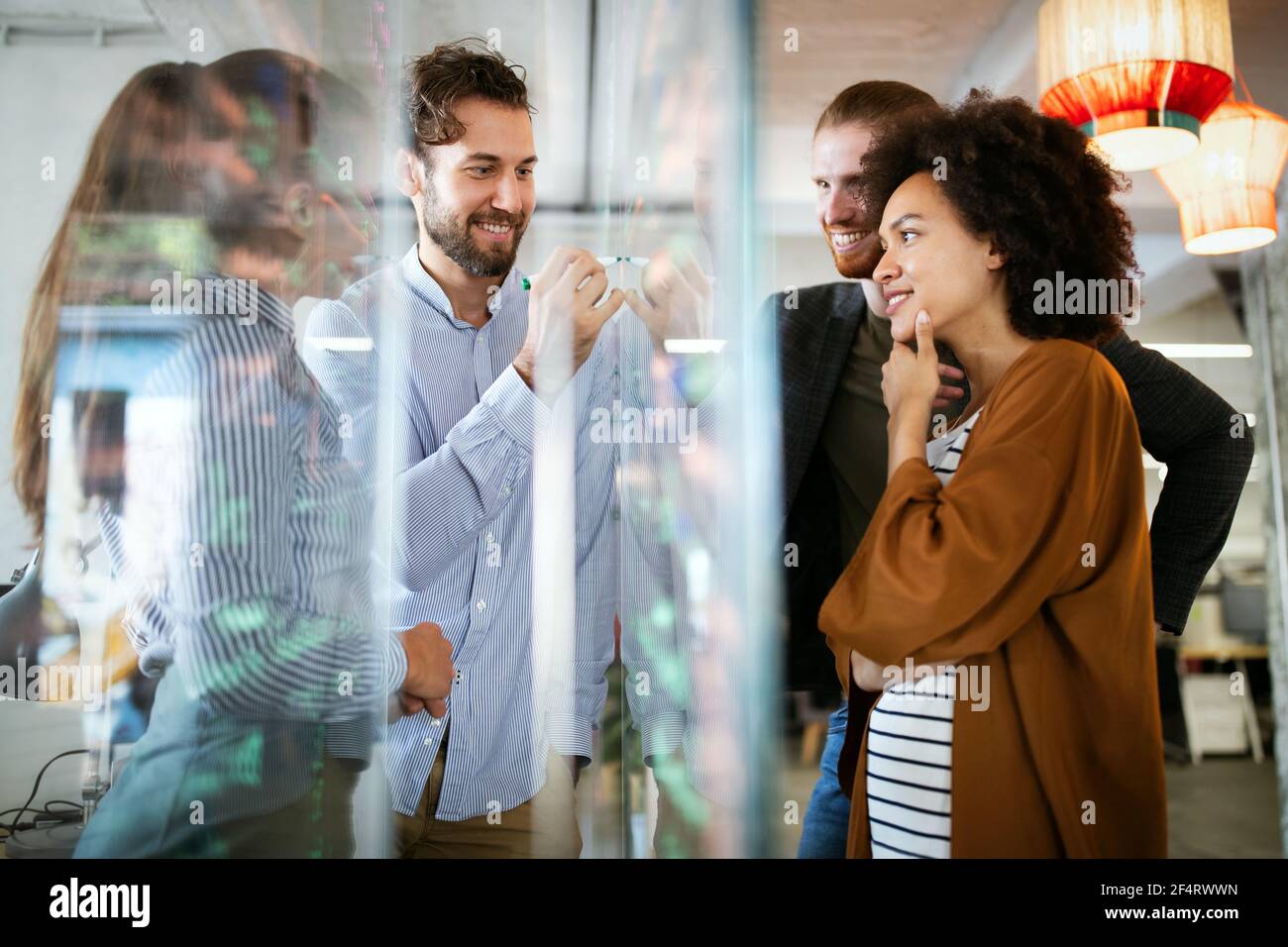 Programmers cooperating brainstorming at information technology company ...