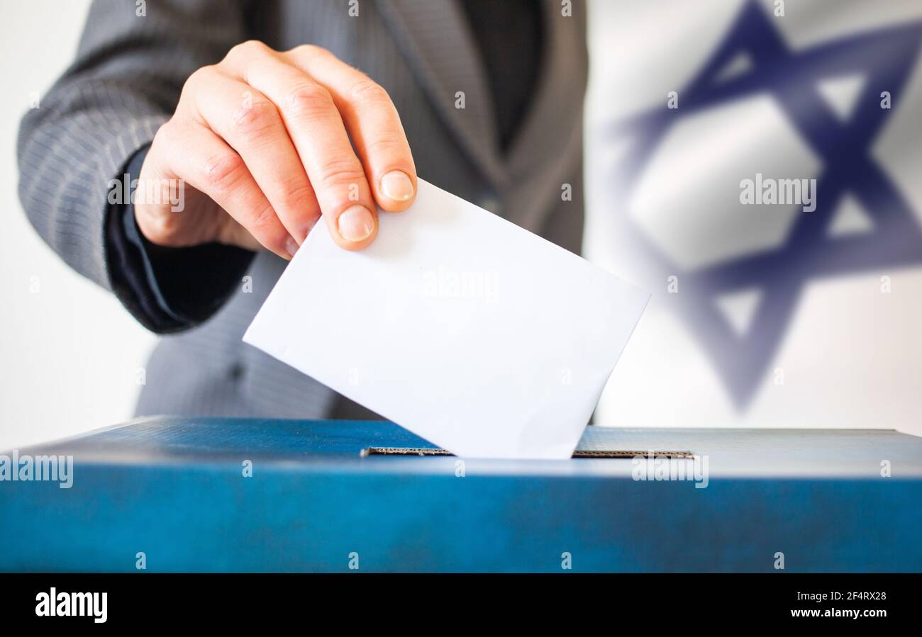 elections in Israel. Hand of a woman putting her vote in the ballot box ...