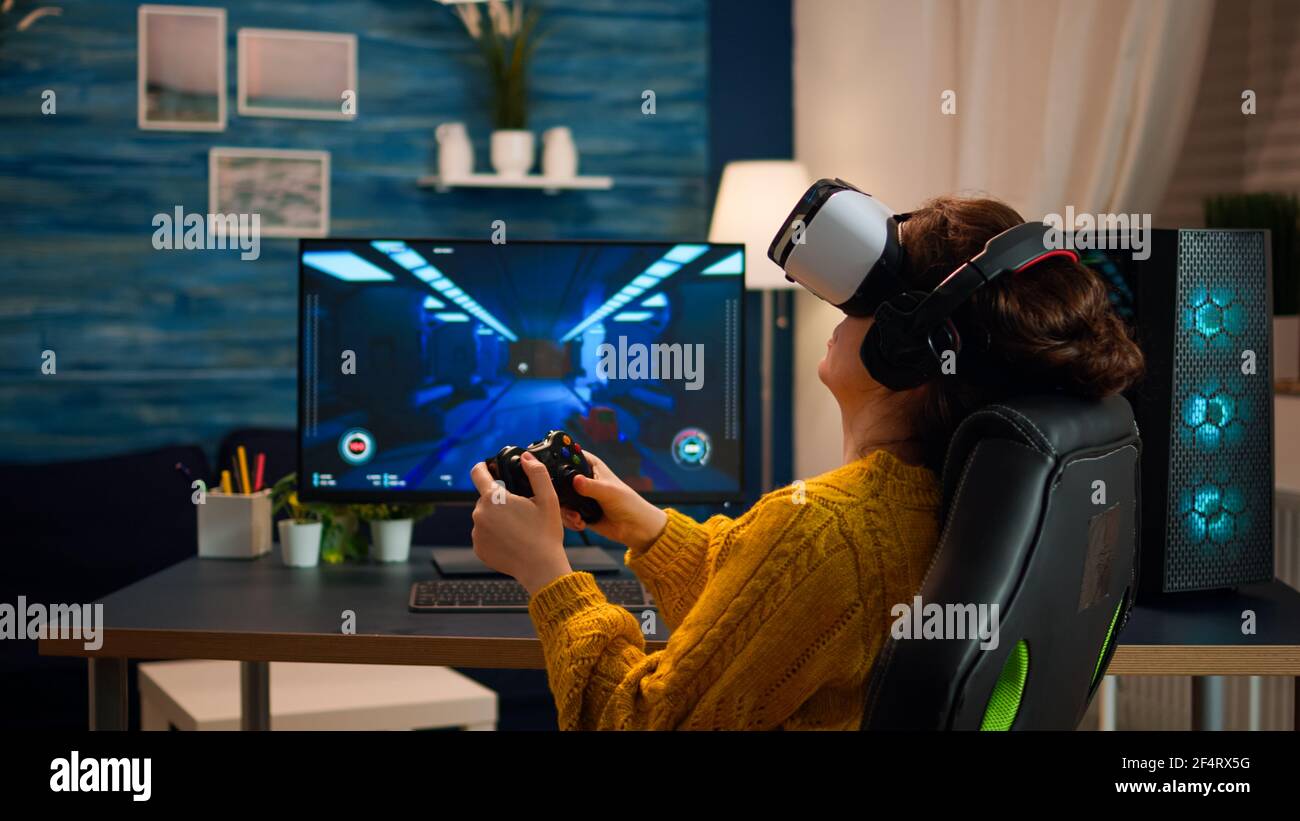 Professional gamer wearing virtual reality headset using wireless ...