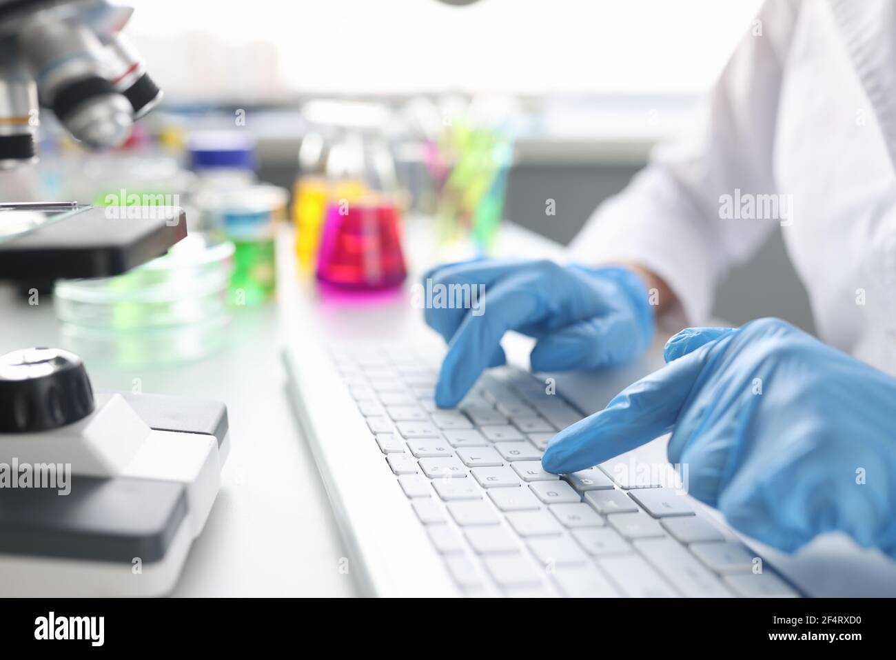Scientist chemist typing on keyboard in laboratory closeup Stock Photo ...
