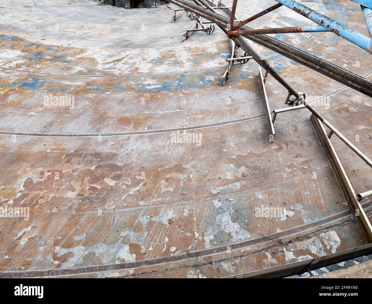 Rusty bottom of a wastewater tank. Sediment removal and sieve cleaning ...