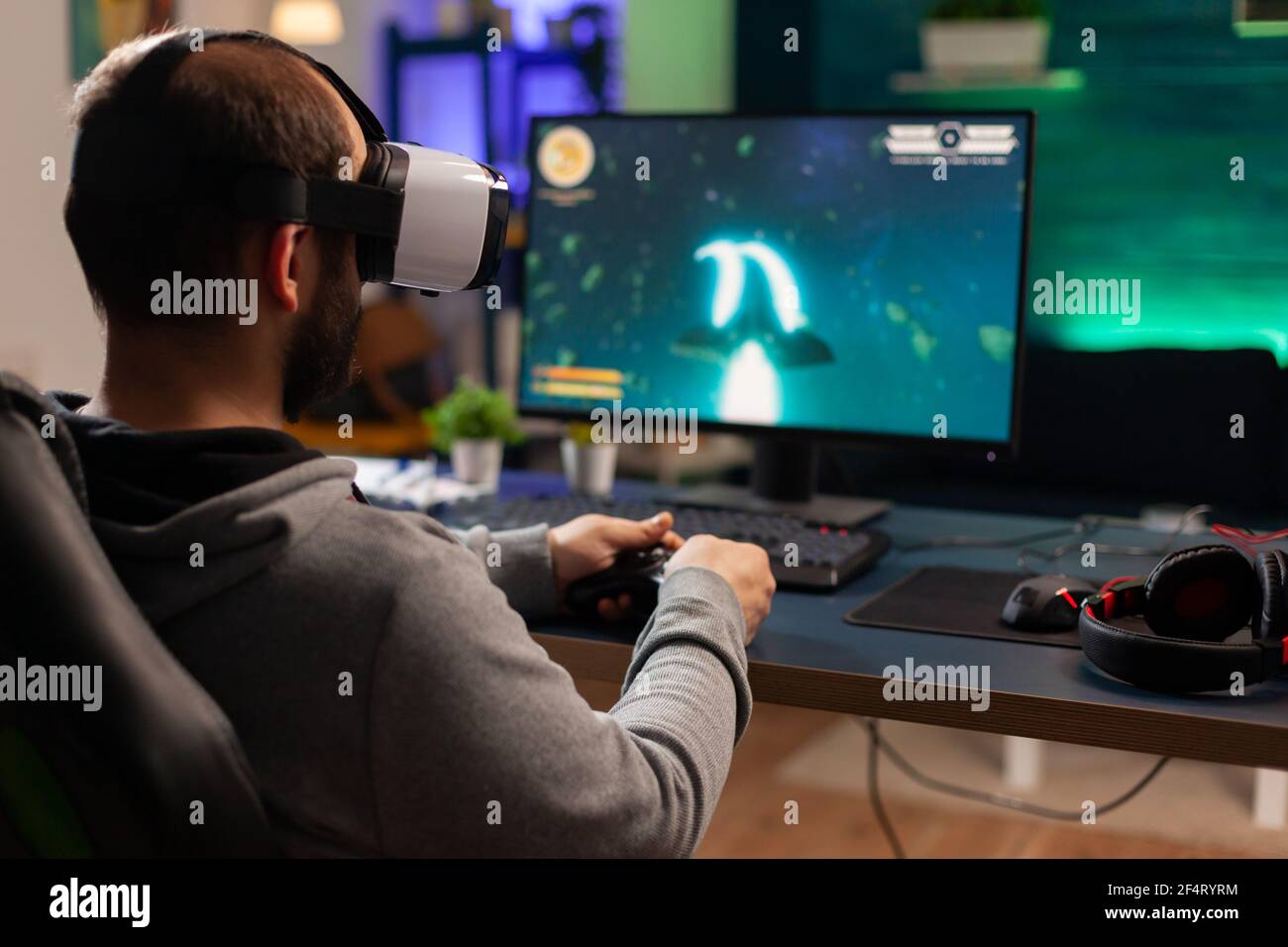 Back view of gamer playing space shooter competition using virtual ...