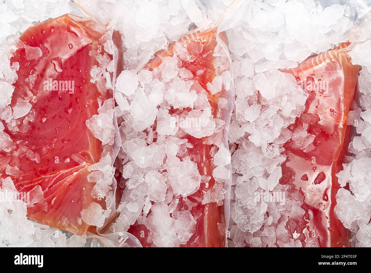 Frozen Tuna steak vacuum with ice on the counter the fishmarket. healfy ...