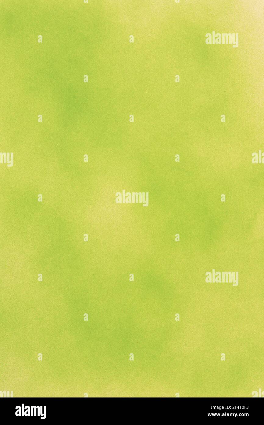 green spray paint on a gray colored paper background Stock Photo - Alamy