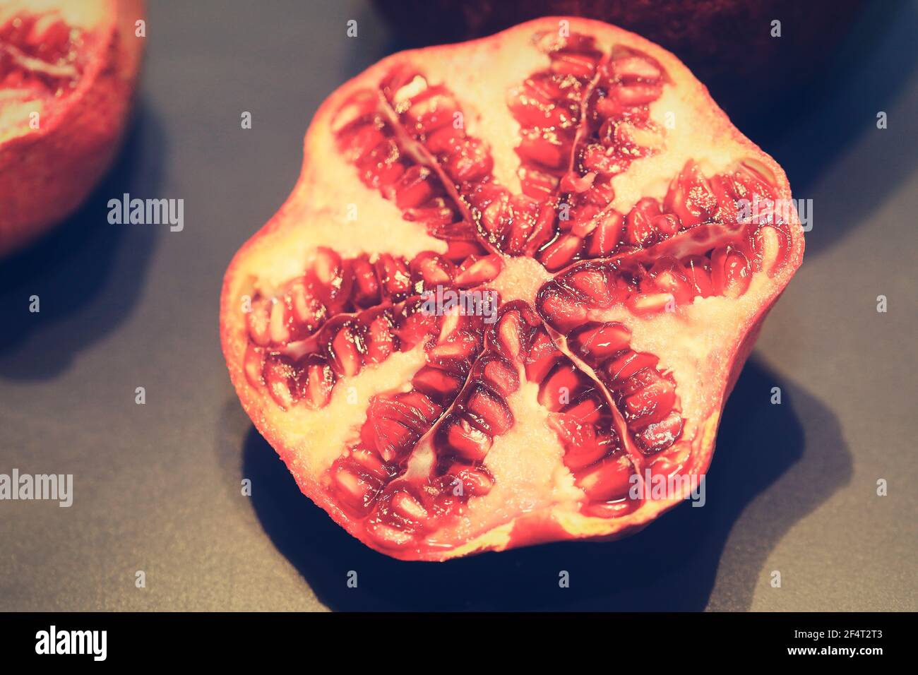 Fresh pomegranate, half cut an full fruit Stock Photo - Alamy