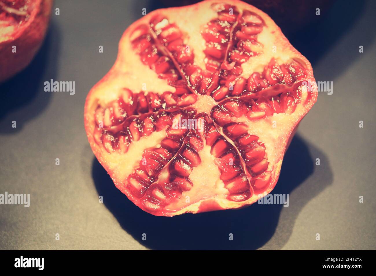 Fresh pomegranate, half cut an full fruit Stock Photo - Alamy