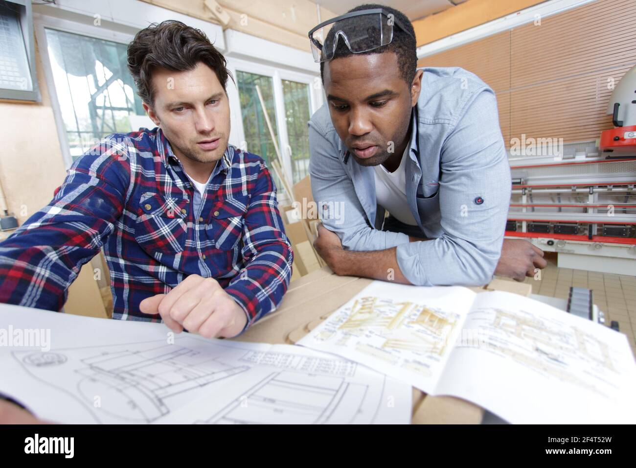 two men looking at plans Stock Photo - Alamy