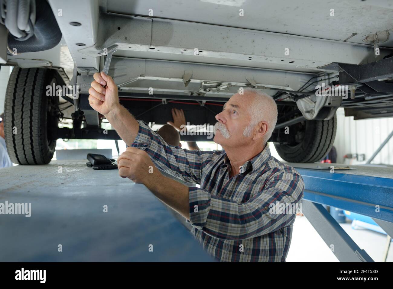 man checking under the car Stock Photo - Alamy