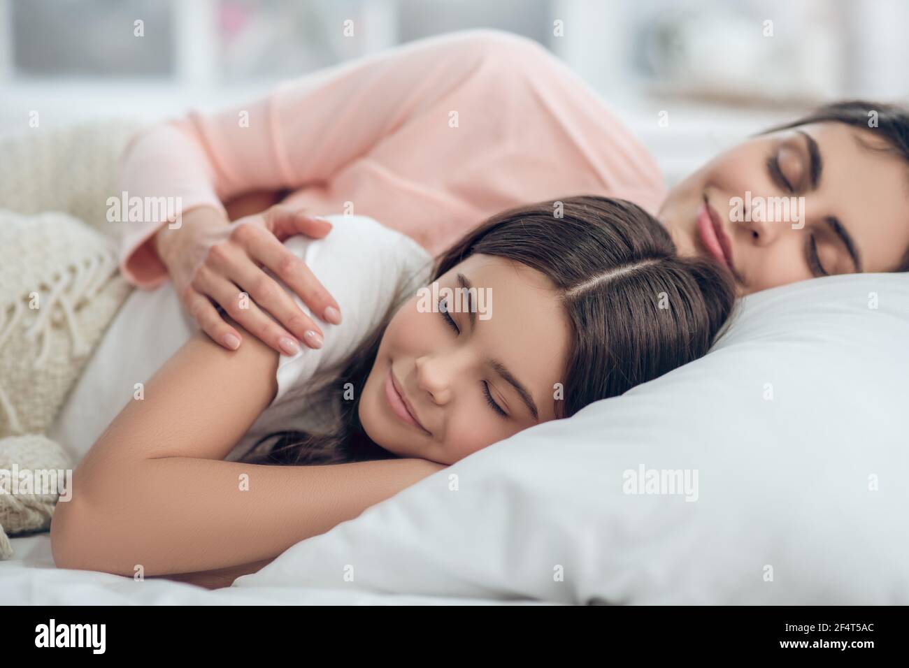 Mom and daughter having rest with closed eyes Stock Photo - Alamy