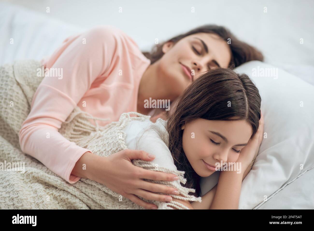 Mom with teenage daughter sleeping next to Stock Photo - Alamy
