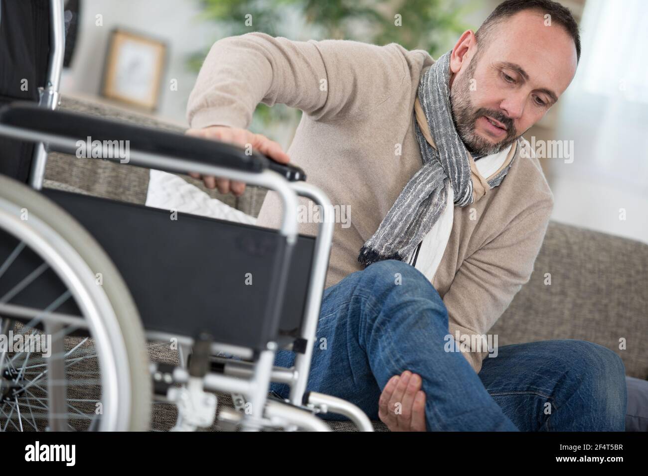 man on wheelchair trying to move independently Stock Photo - Alamy
