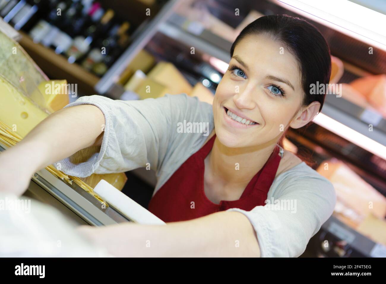 happy female cheese worker Stock Photo - Alamy
