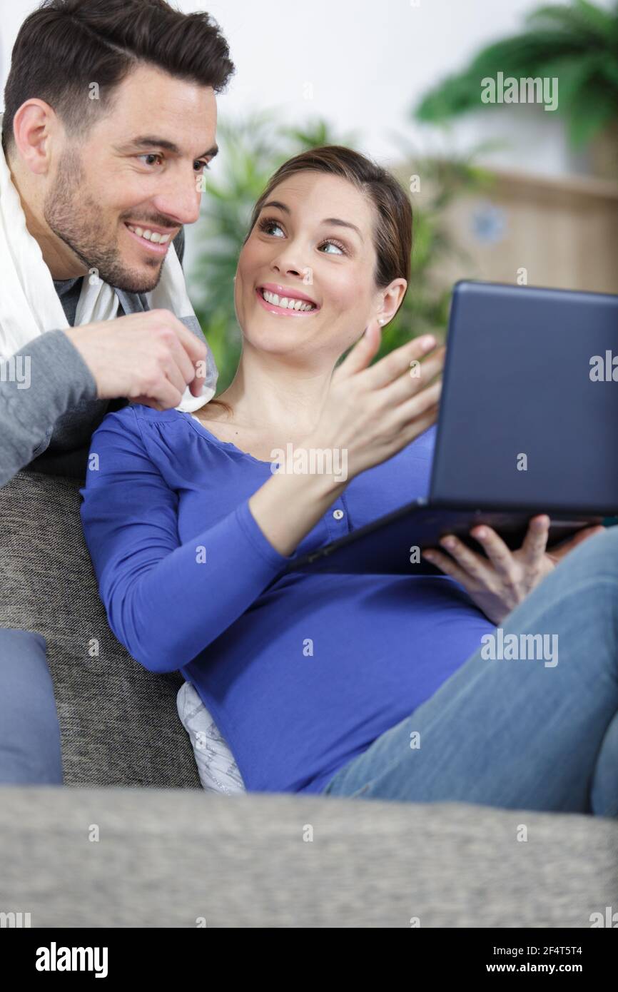 happy married couple using computer purchasing online Stock Photo - Alamy
