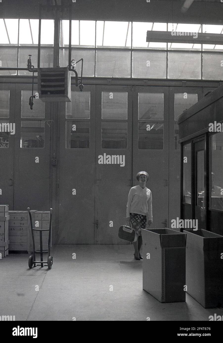 1964, historical, female office worker outside her partitioned office ...
