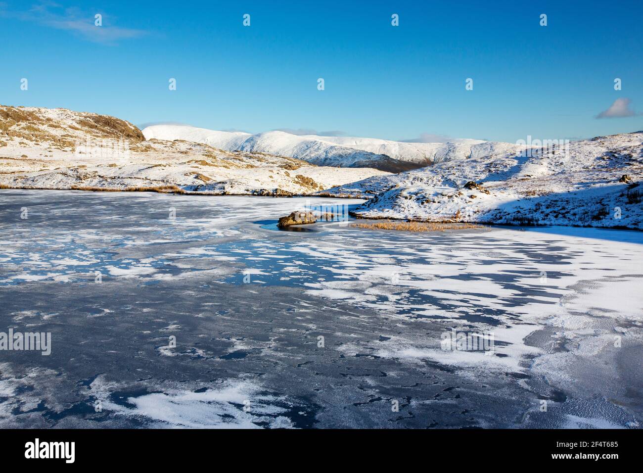 Codale Tarn frozen in winter above Grasmere, Lake District, UK Stock ...