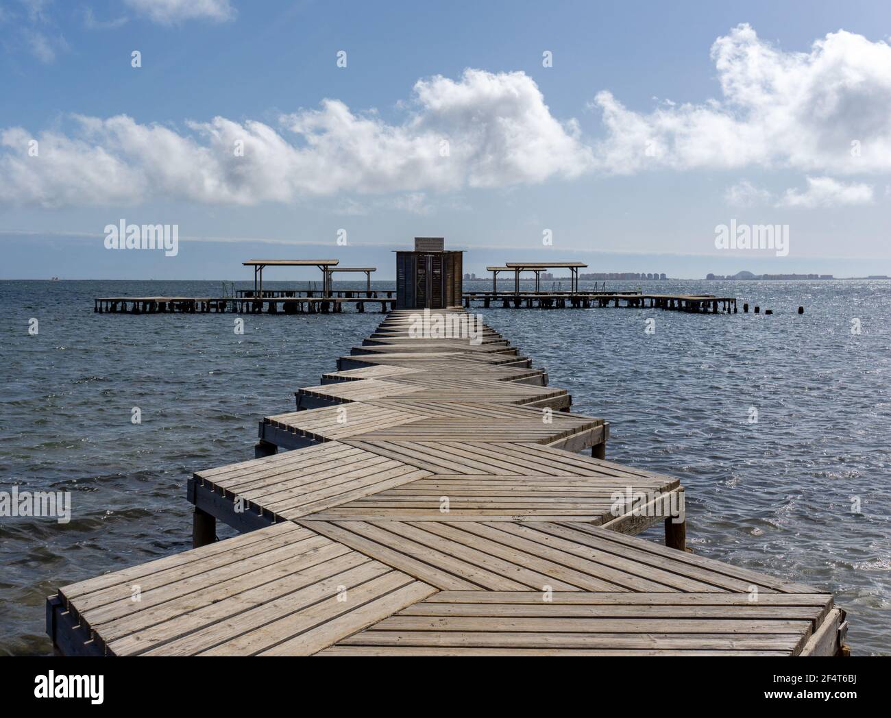 A wooden boardwalk leading out into the ocean to a public bath ...