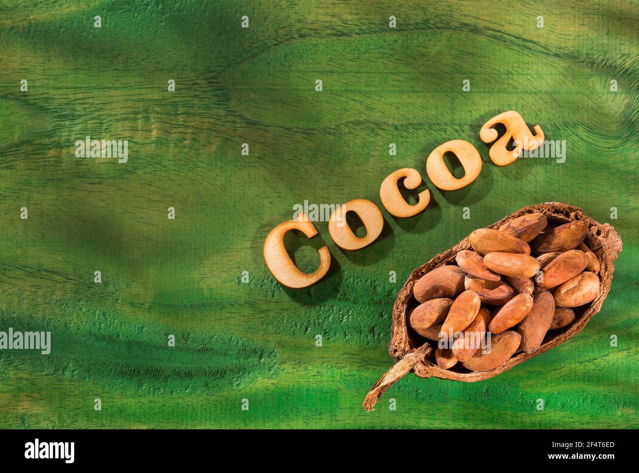 Theobroma cacao - Organic cocoa beans. Cocoa word in wooden letters ...