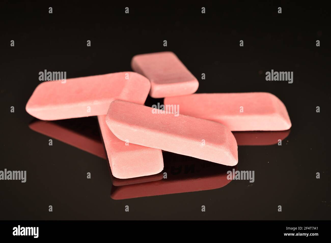 Several red office erasers, close-up. The background is black Stock ...