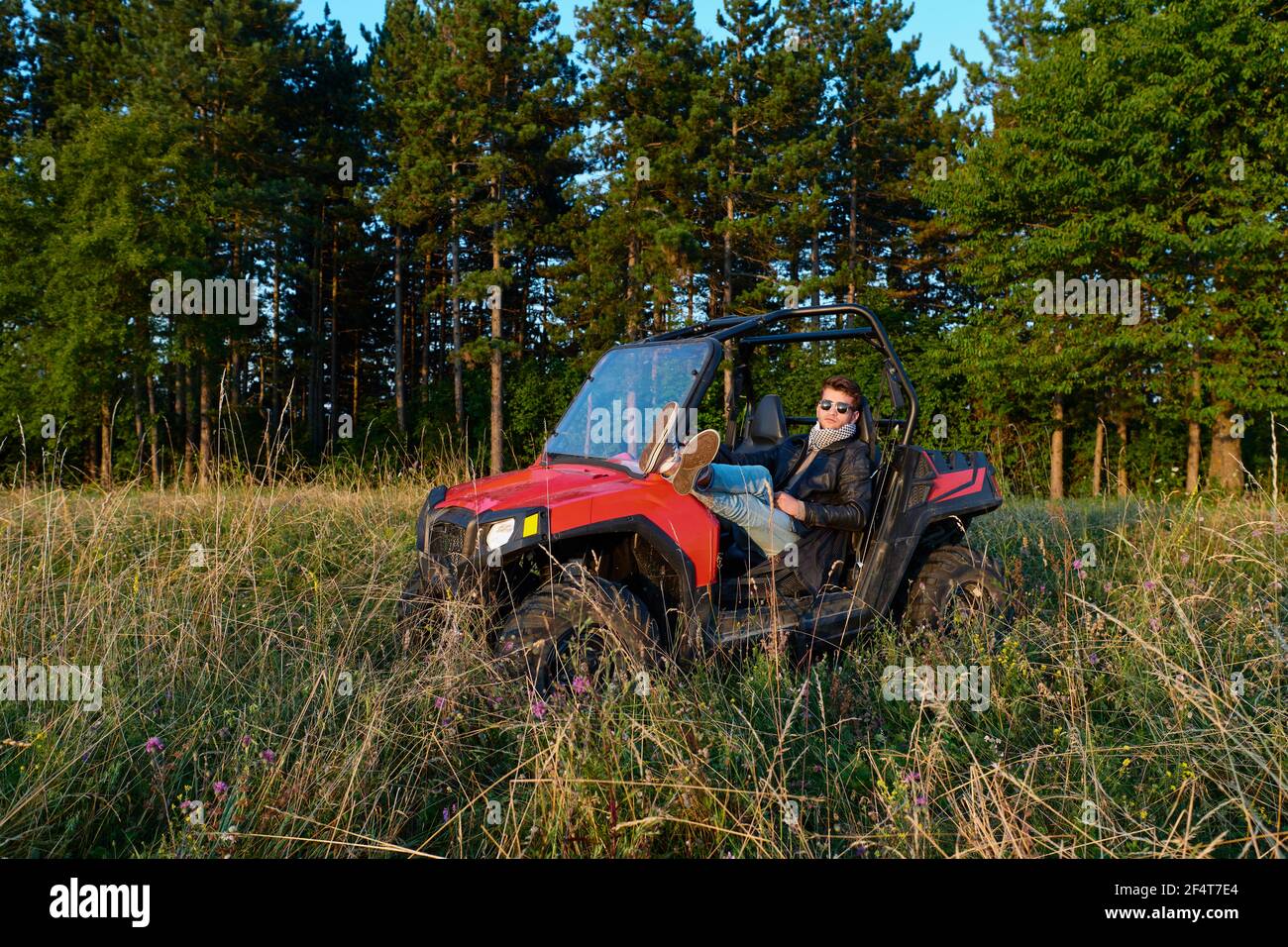 man enjoying beautiful sunny day while driving a off road buggy car ...