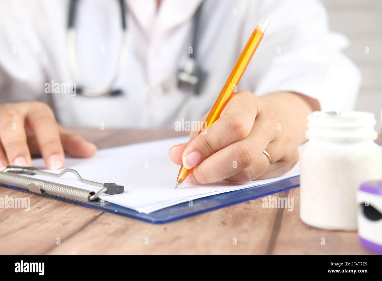 female doctor hand writing prescription on desk, close up Stock Photo ...