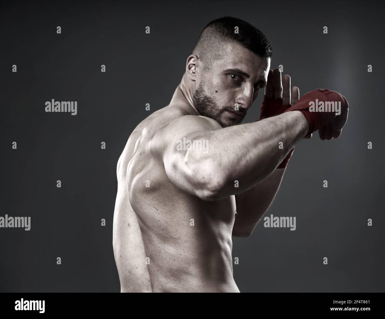 MMA fighter training, throwing an elbow strike, isolated on gray ...