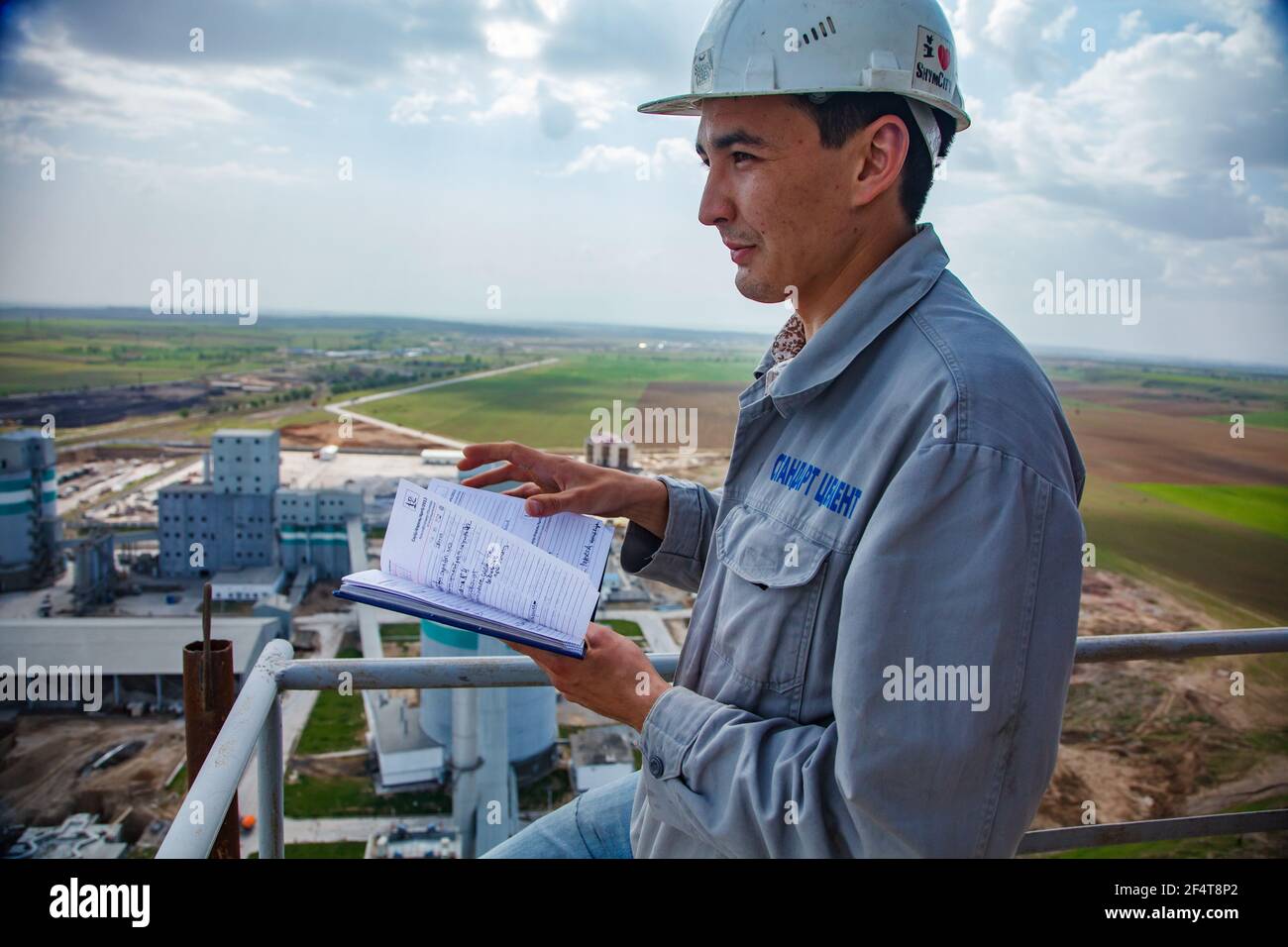 Standard Cement plant. Young Asian engineer with notebook on cement ...