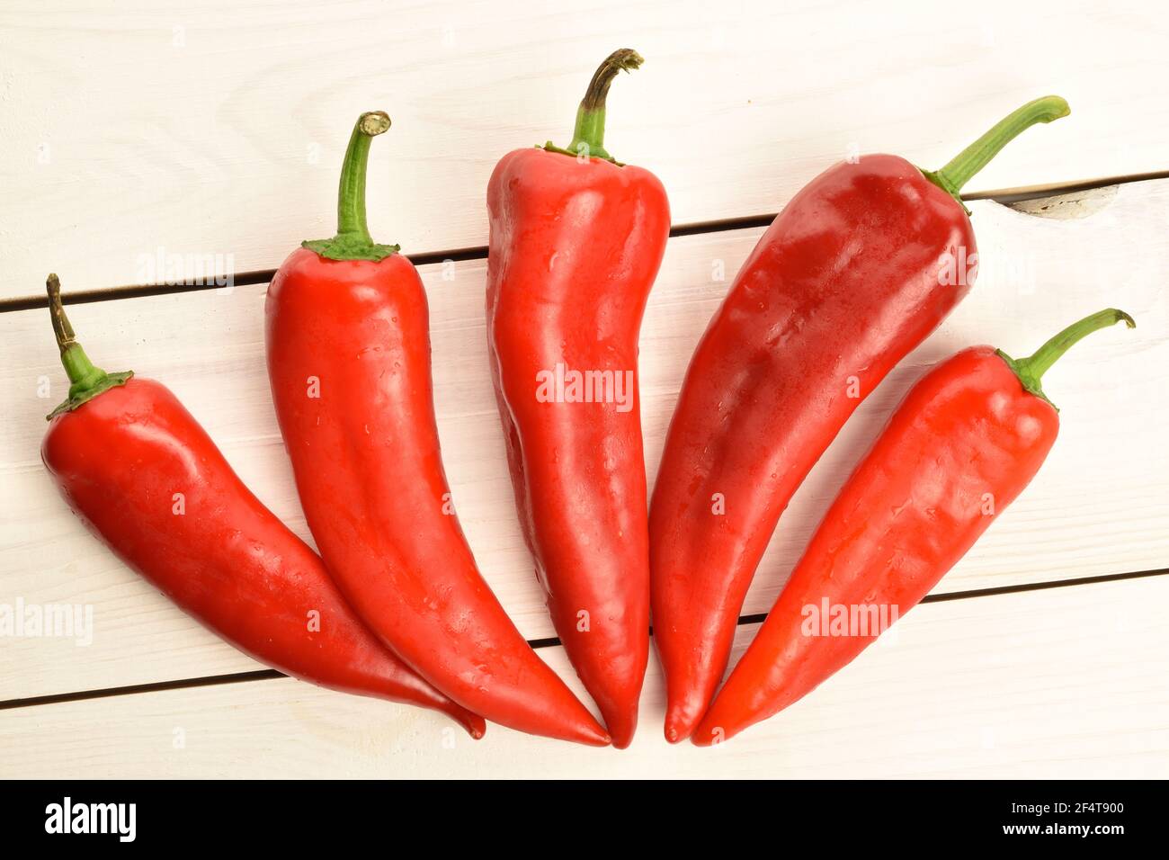 A few ripe organic tasty sweet Kapia peppers on a natural wood ...