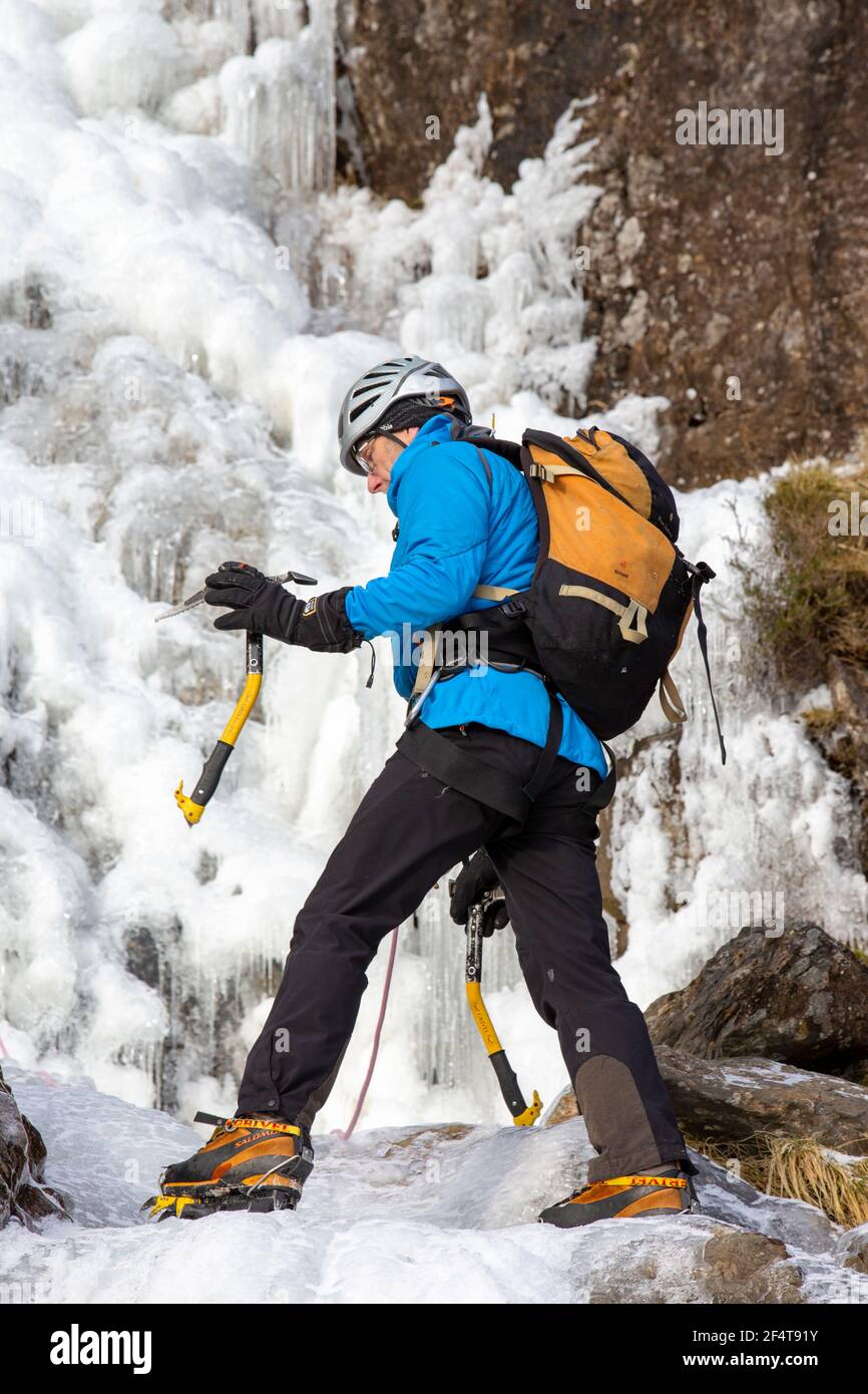 Ice climbers climbing Low Water Beck frozen in winter on the slopes of ...
