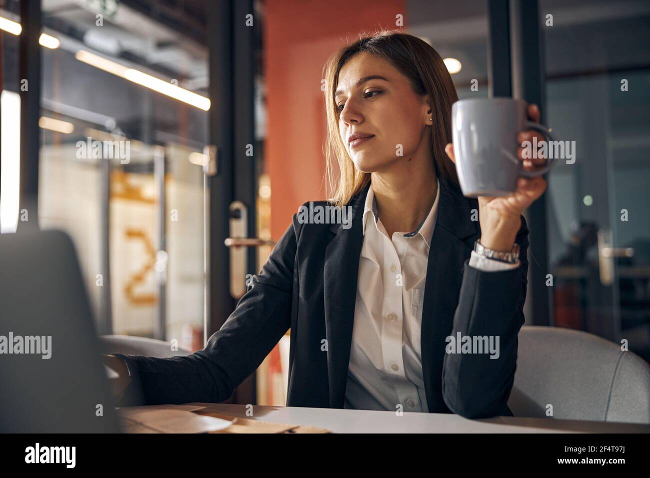 Serious female employee concentrated on her office work Stock Photo - Alamy