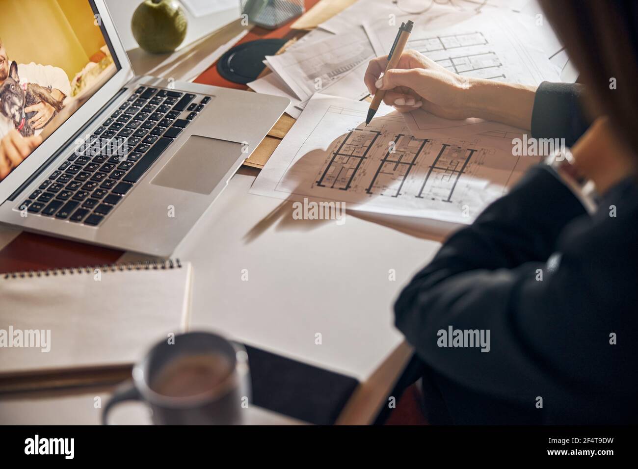 Architect making corrections to a house plan with a ball-point pen ...