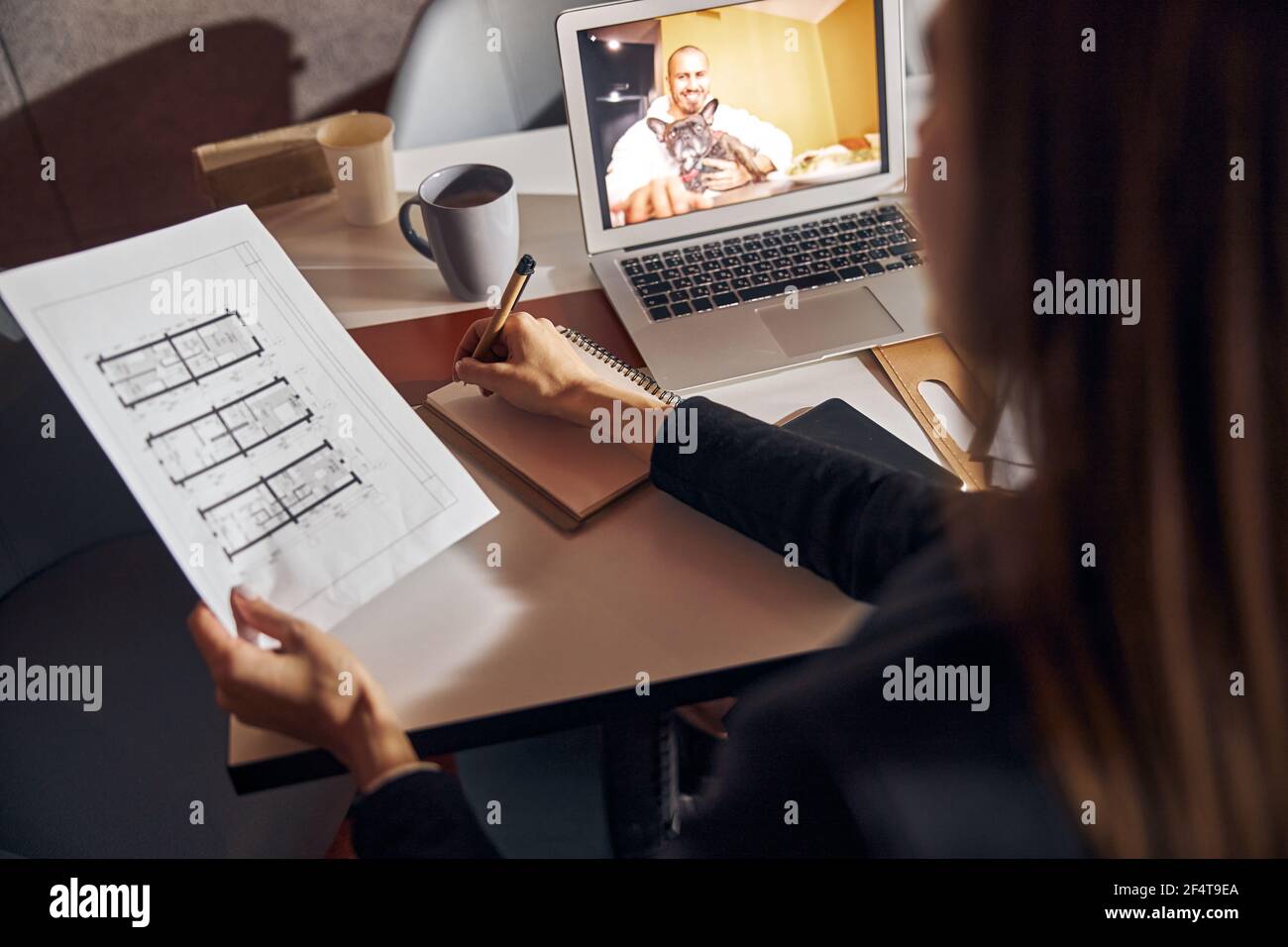 Long-haired female engineer working at a new floor plan Stock Photo - Alamy