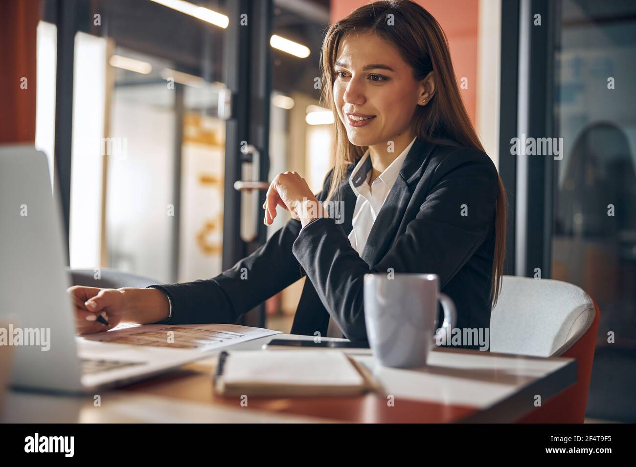Draftswoman sitting at the desk with technical drawings on it Stock ...