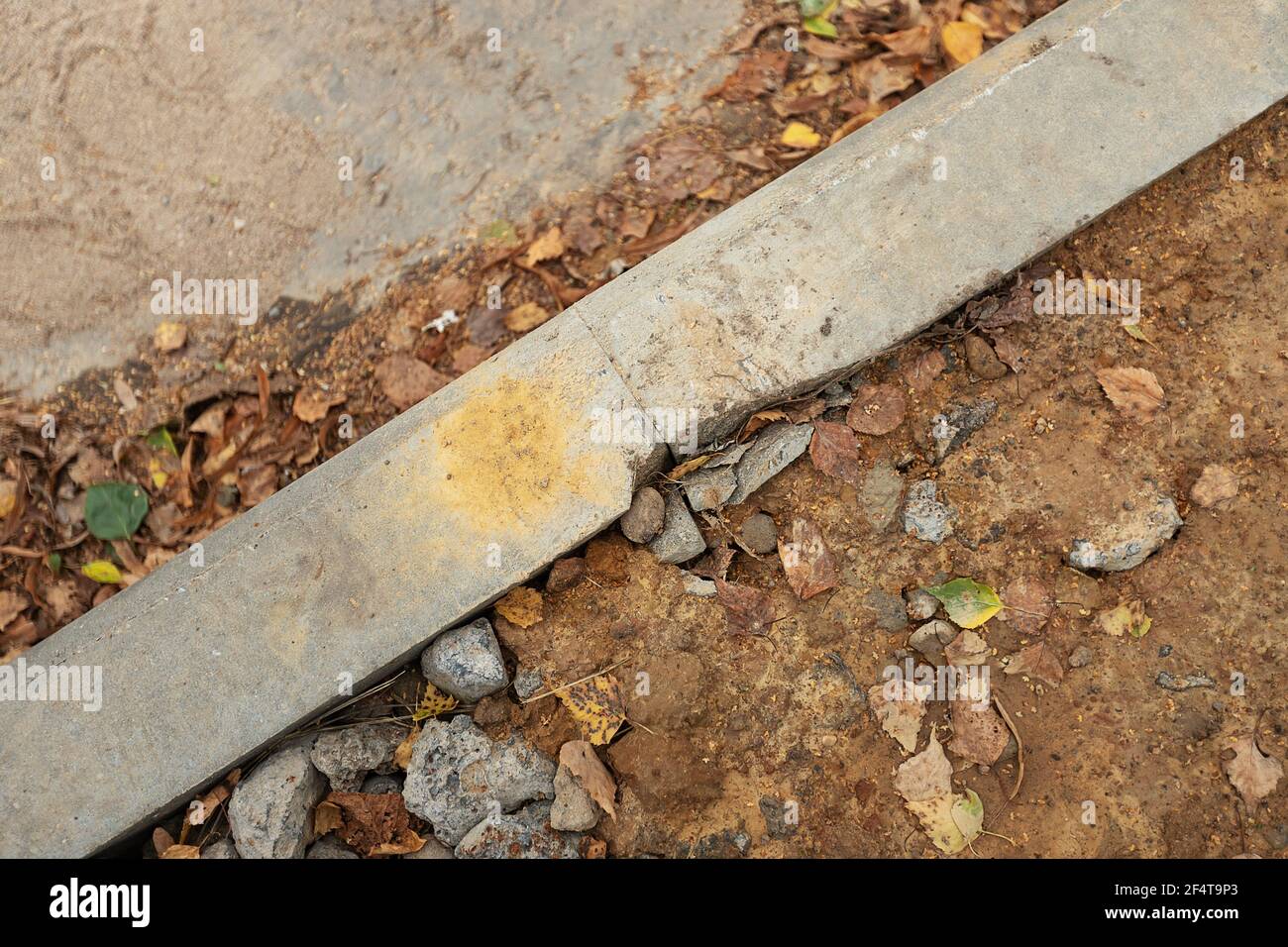 poorly executed road repairs. replacing the old curb stone with a new ...